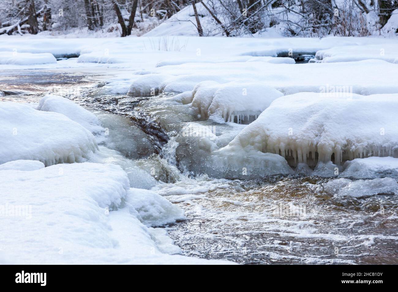Frozen river with snow and ice Stock Photo - Alamy