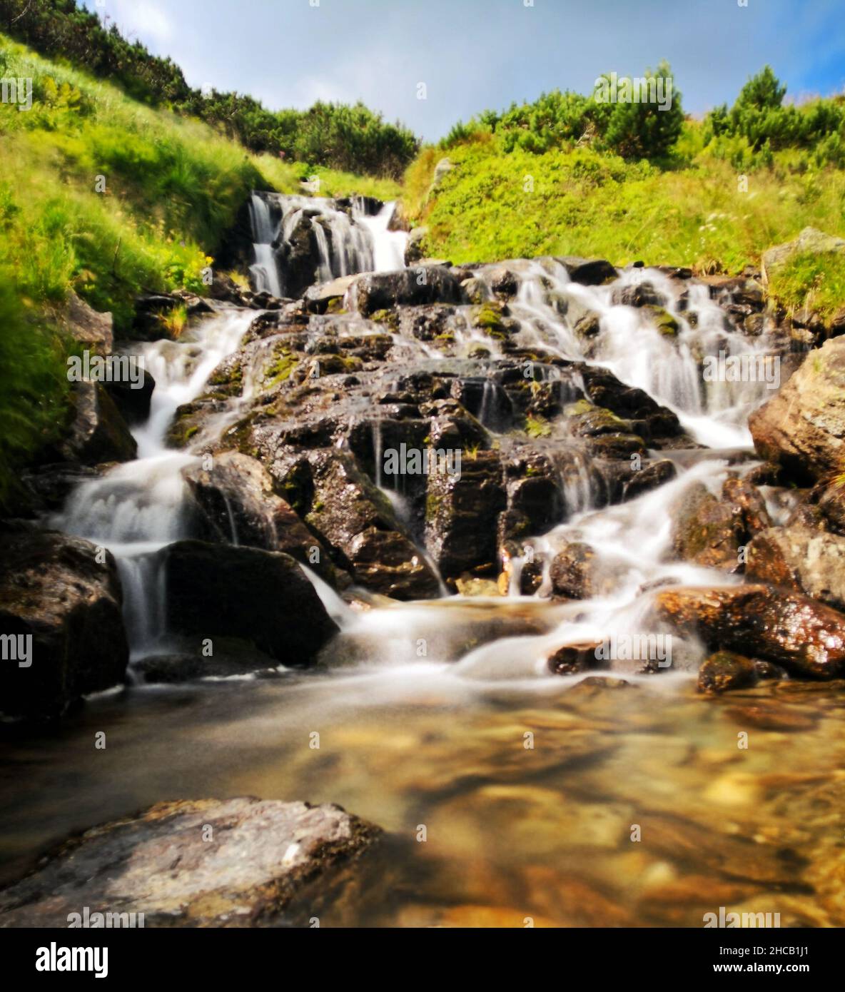 Natural view of waterfall flowing downstream under a sunny day Stock ...
