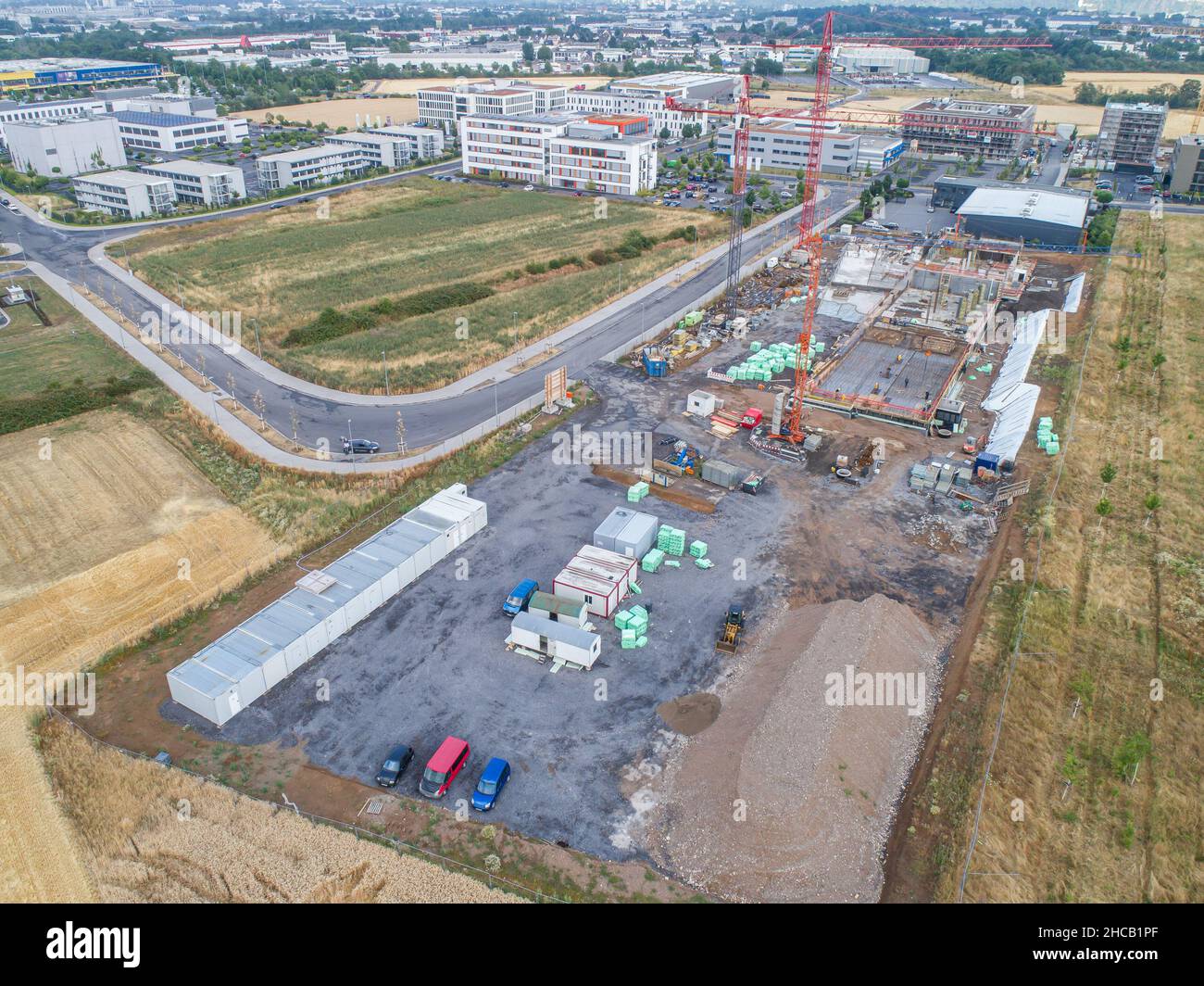 aerial concrete construction yard building site crane cloudy sky ...