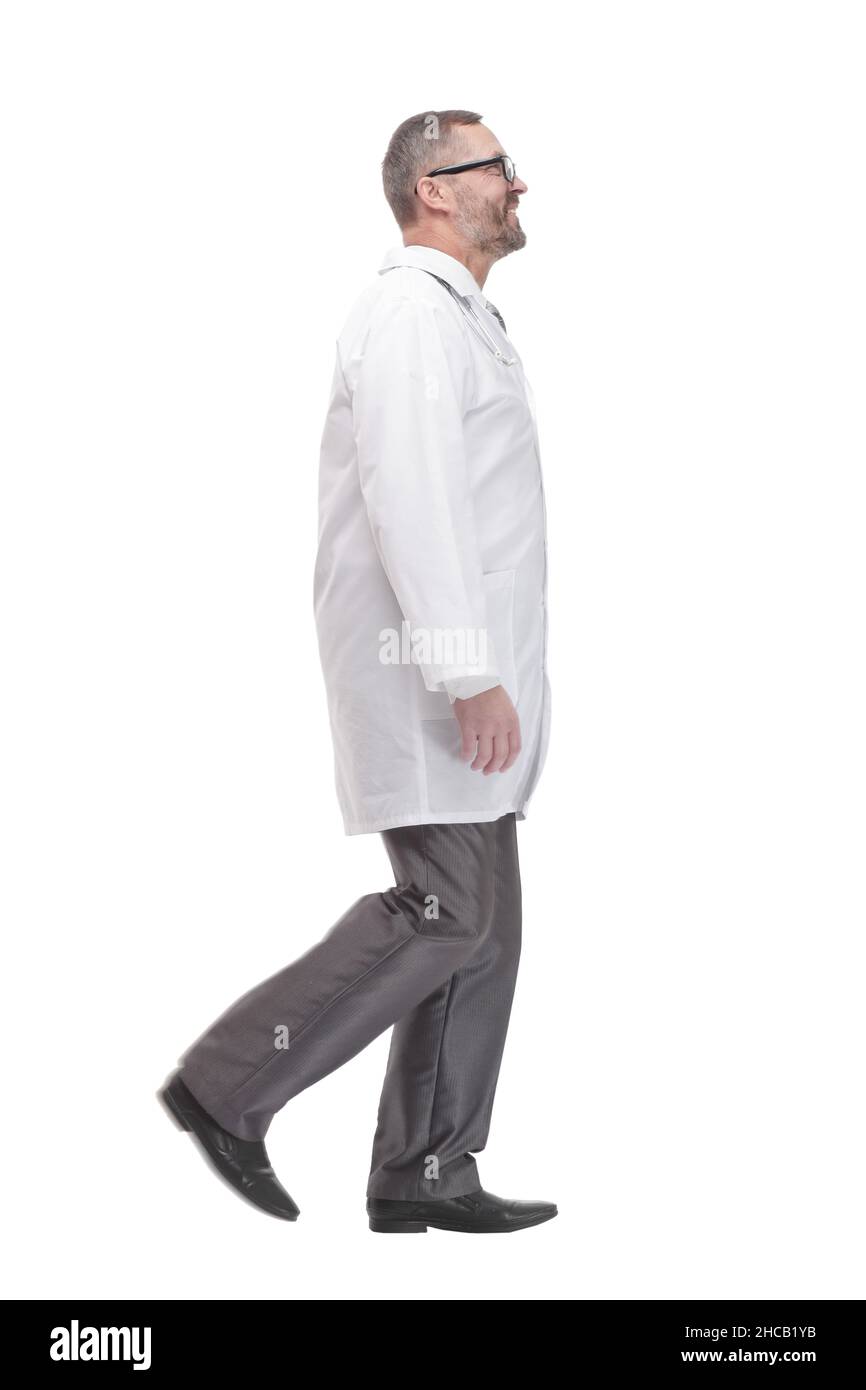 Mature male doctor striding forward. isolated on a white background ...