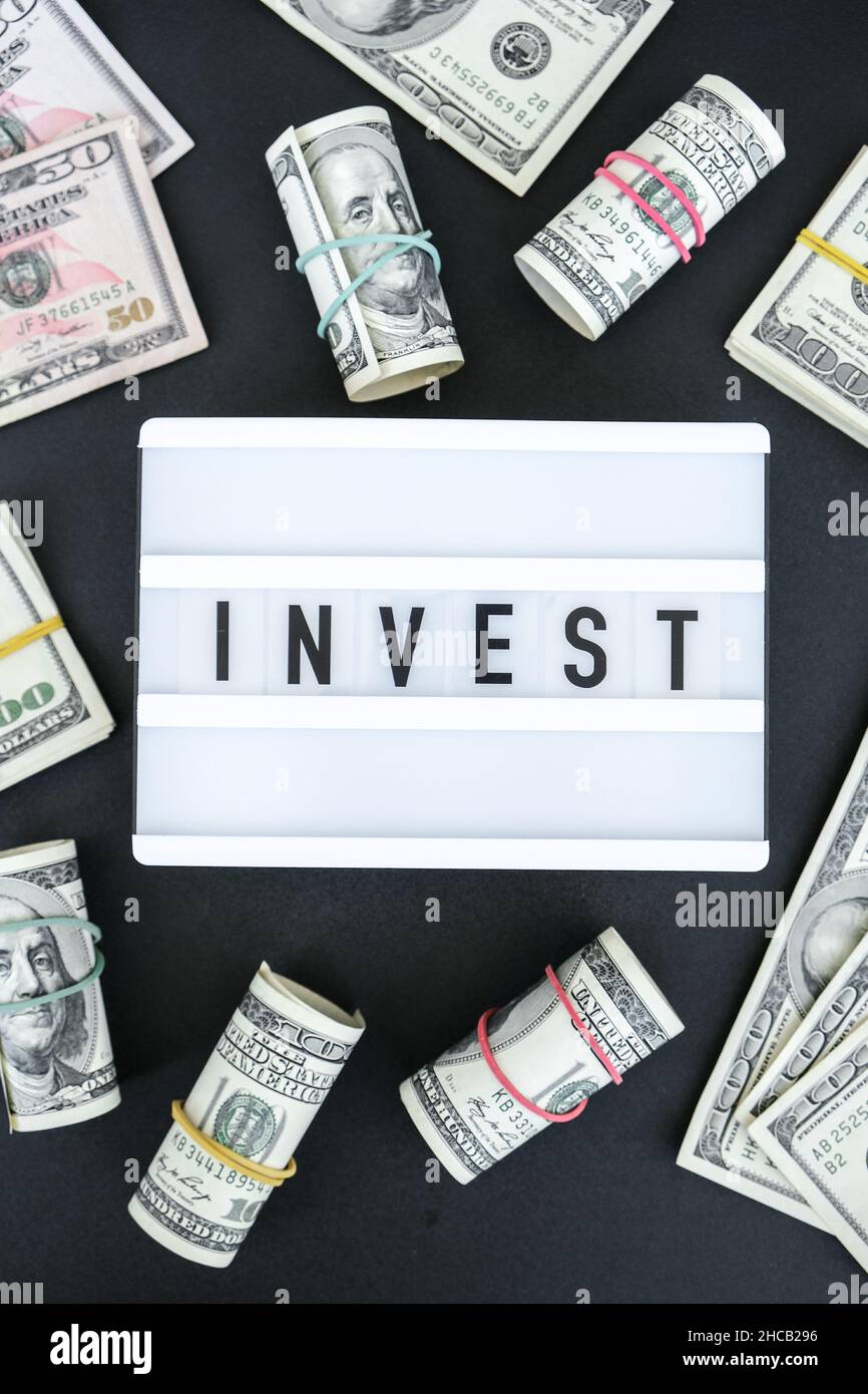 Lightbox board with word INVEST in black letters around US dollar ...