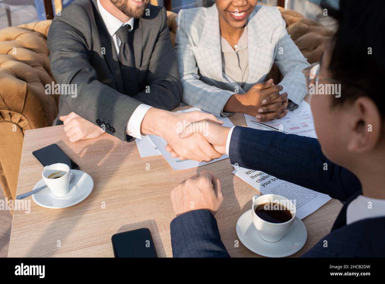 Business handshake over coffee hi-res stock photography and images - Alamy