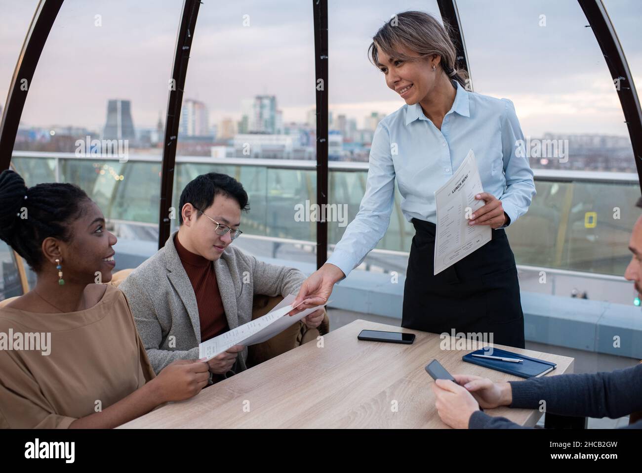 Woman bending over table hi-res stock photography and images - Alamy