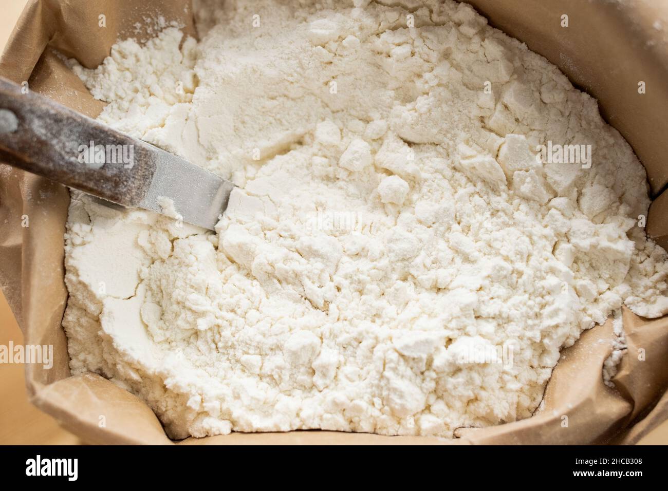 Overview of pile of fresh wheat flour in eco-friendly paper sack and ...