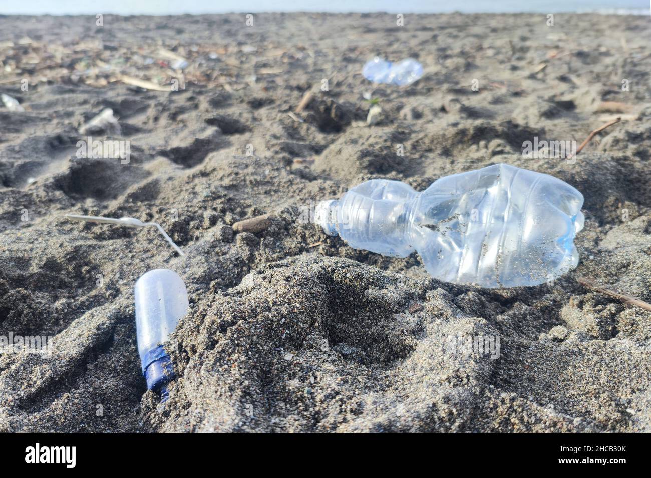 Plastic waste rubbish garbage on the sandy beach Stock Photo - Alamy