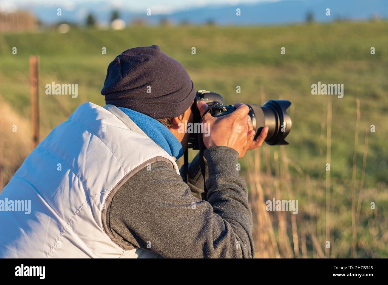 Photographer taking authentic outdoor photos in autumn landscape by big ...