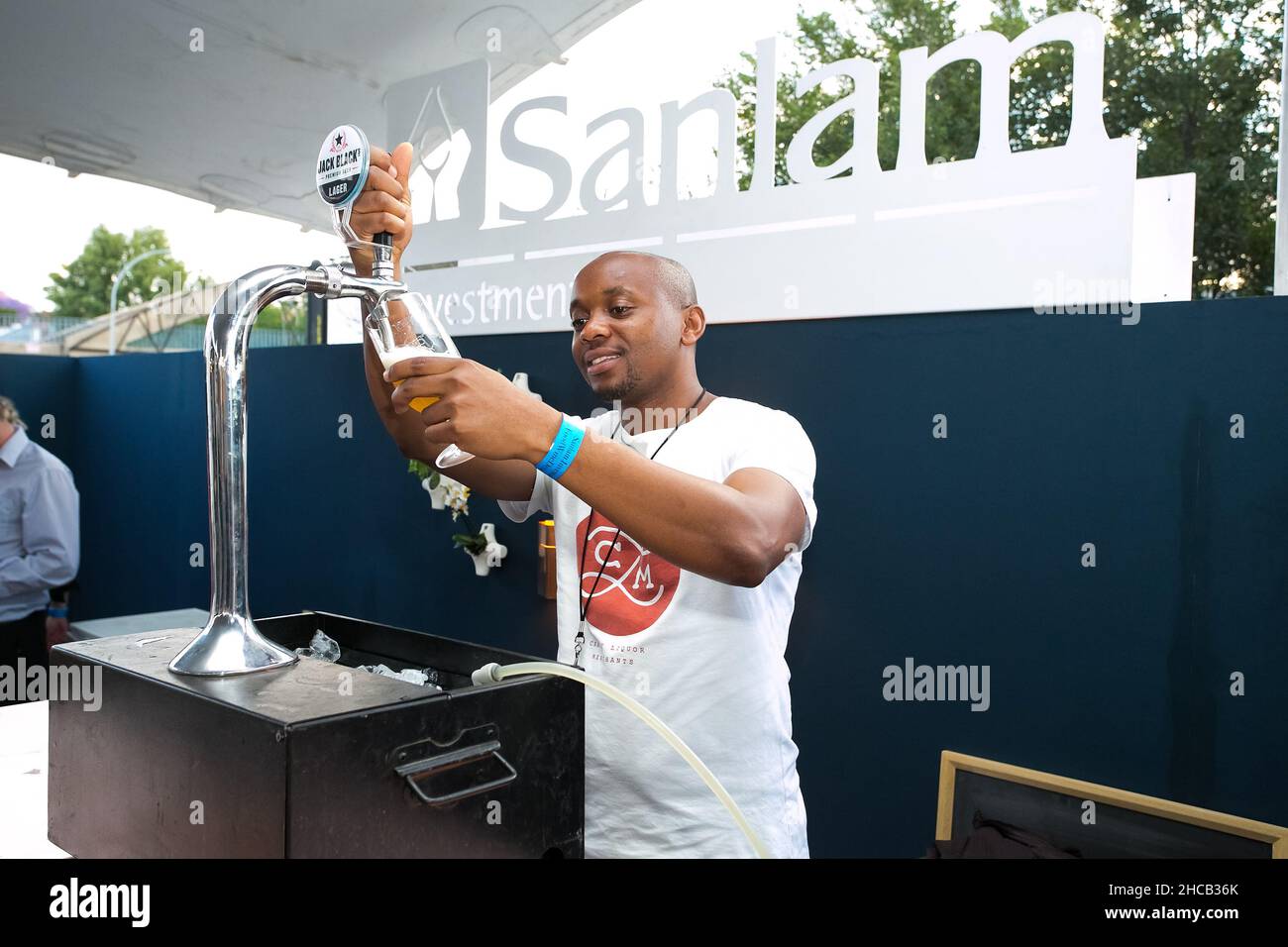 African Barman pouring a drink at a VIP lounge in Johannesburg, South ...
