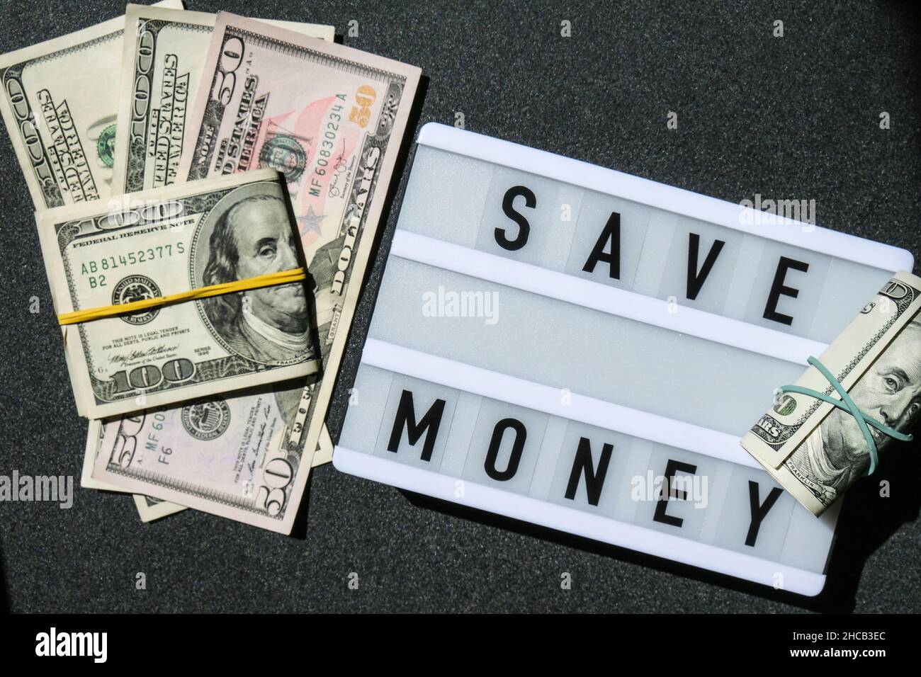 Lightbox board with word SAVE MONEY in black letters around US dollar ...