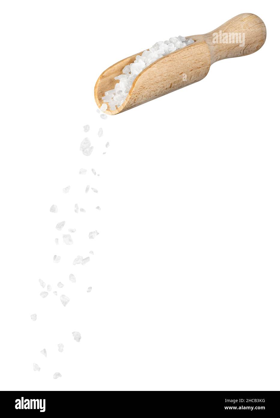 sea salt falling from wooden spoon isolated Stock Photo - Alamy