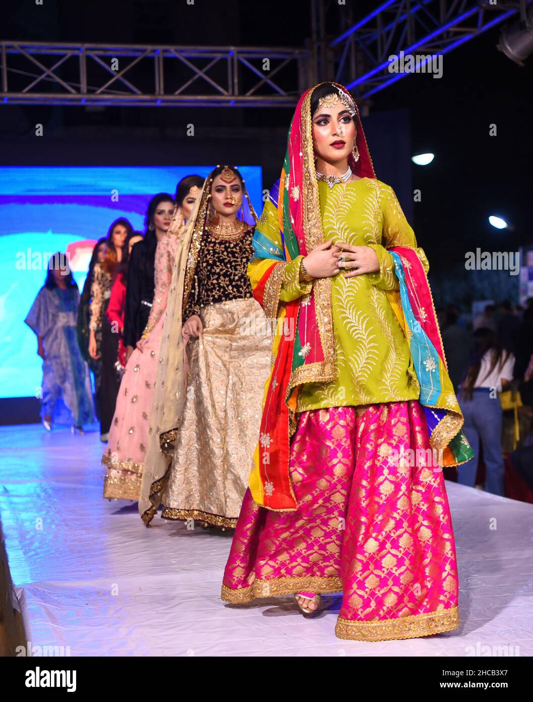 Karachi, Pakistan. 26th Dec, 2021. Models present creations during a ...
