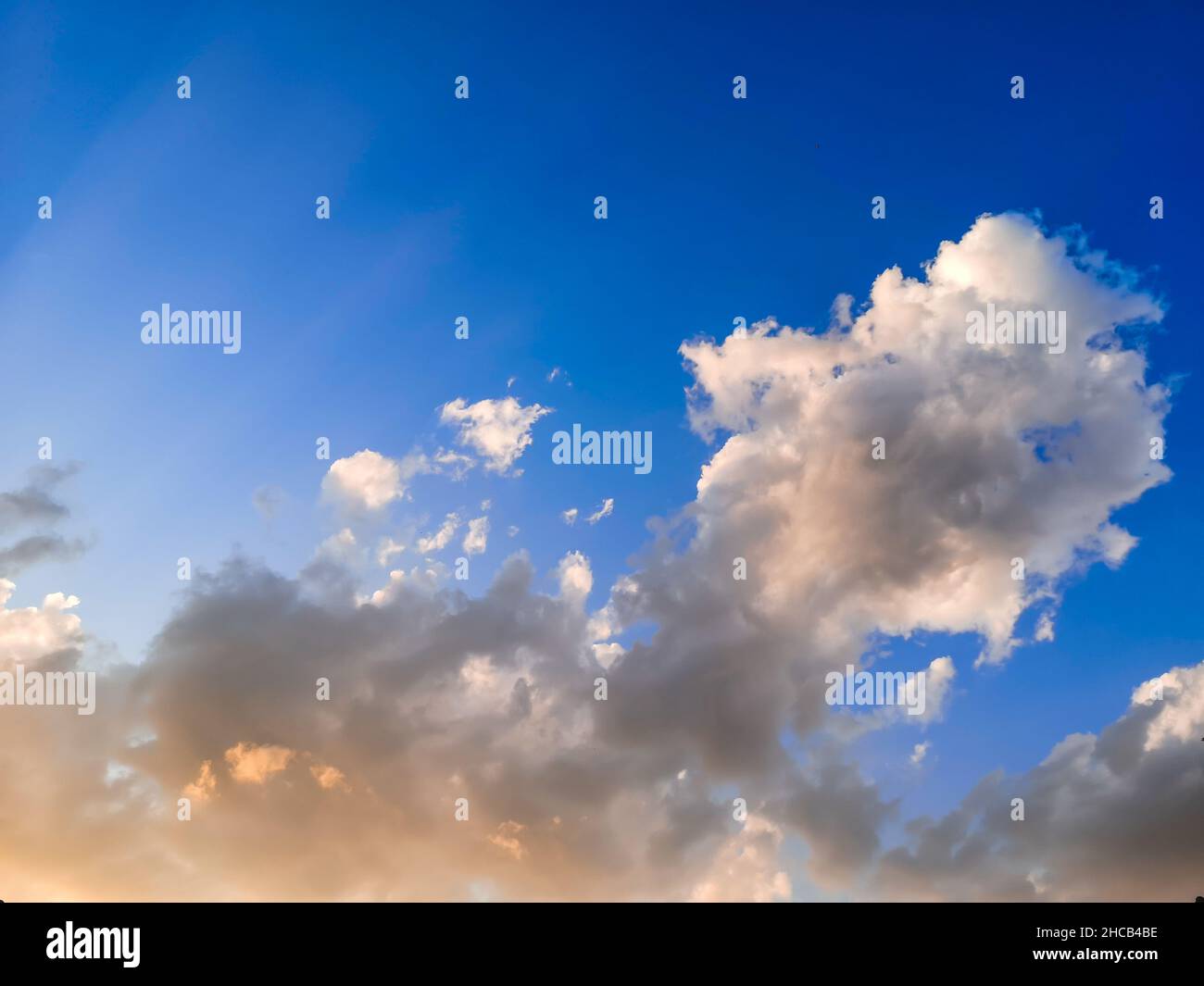 Spectacular blue sky with mistic clouds and rays of lights Stock Photo ...