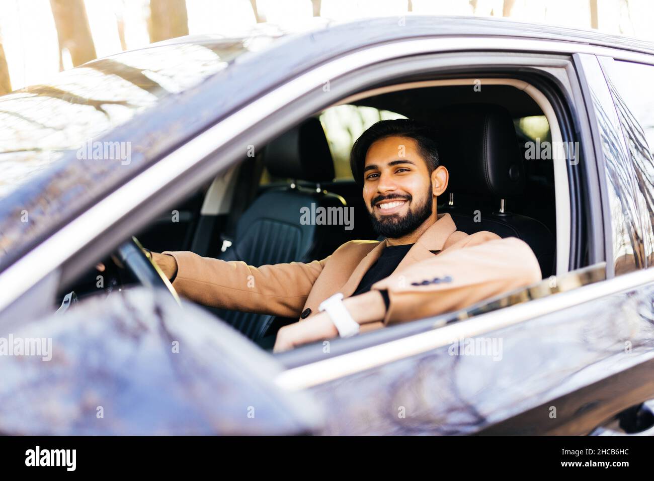Front view of young asian man driving car Stock Photo - Alamy