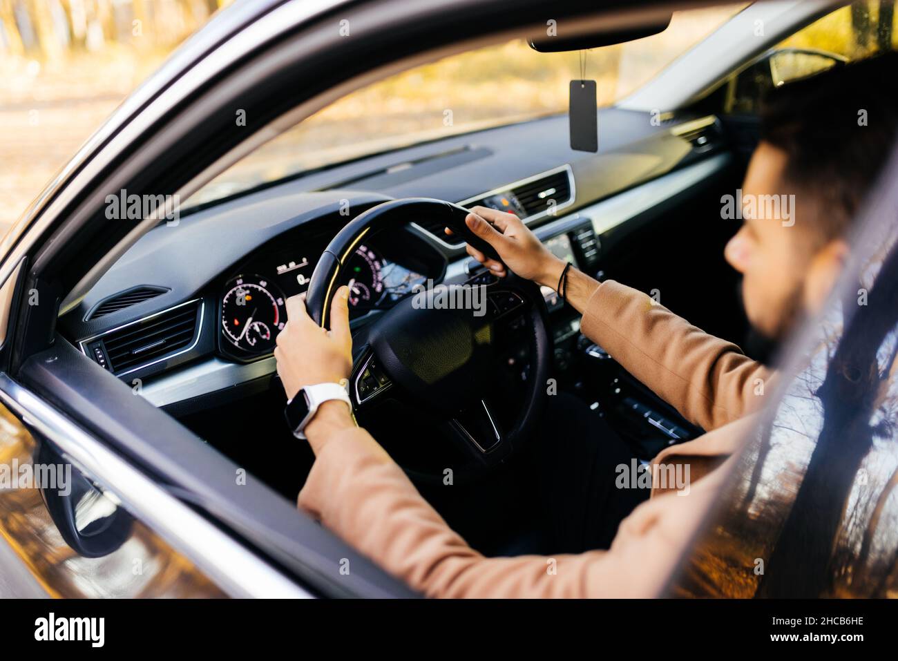 Front view of young asian man driving car Stock Photo - Alamy