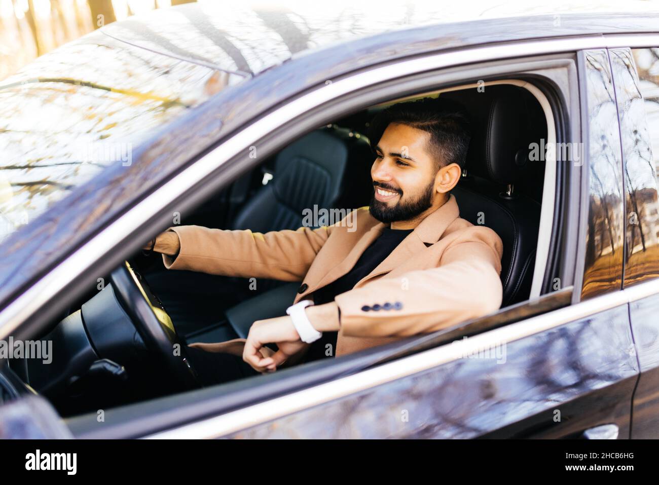 Young indian man driving a car on street Stock Photo - Alamy