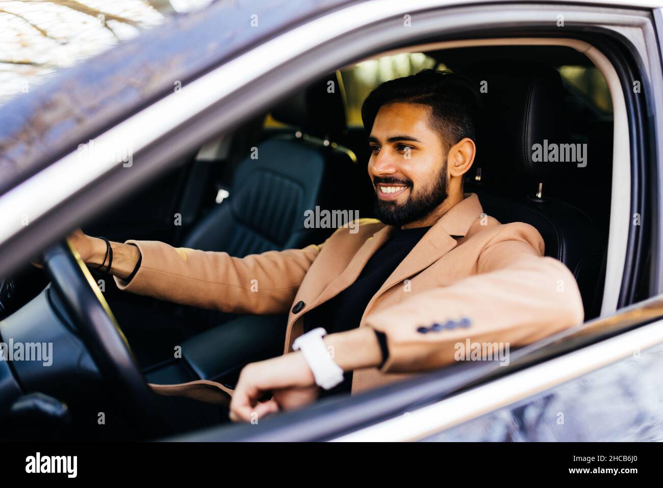 Front view of young asian man driving car Stock Photo - Alamy