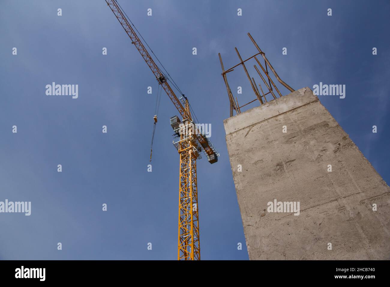 Tower crane and concrete base of the building. Construction crane on ...