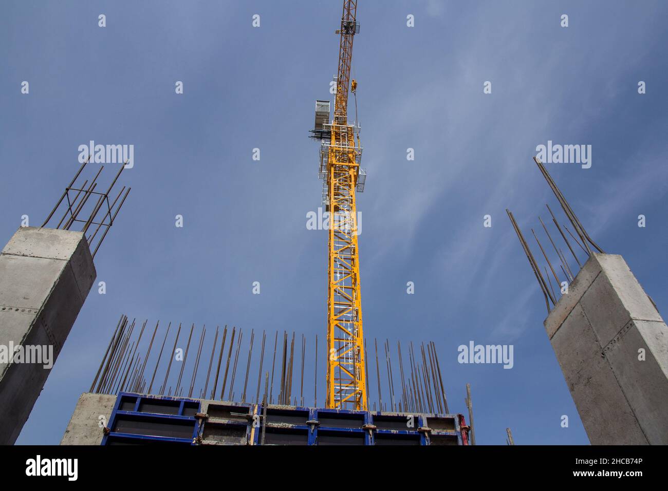 Tower crane and concrete base of the building. Construction crane on ...