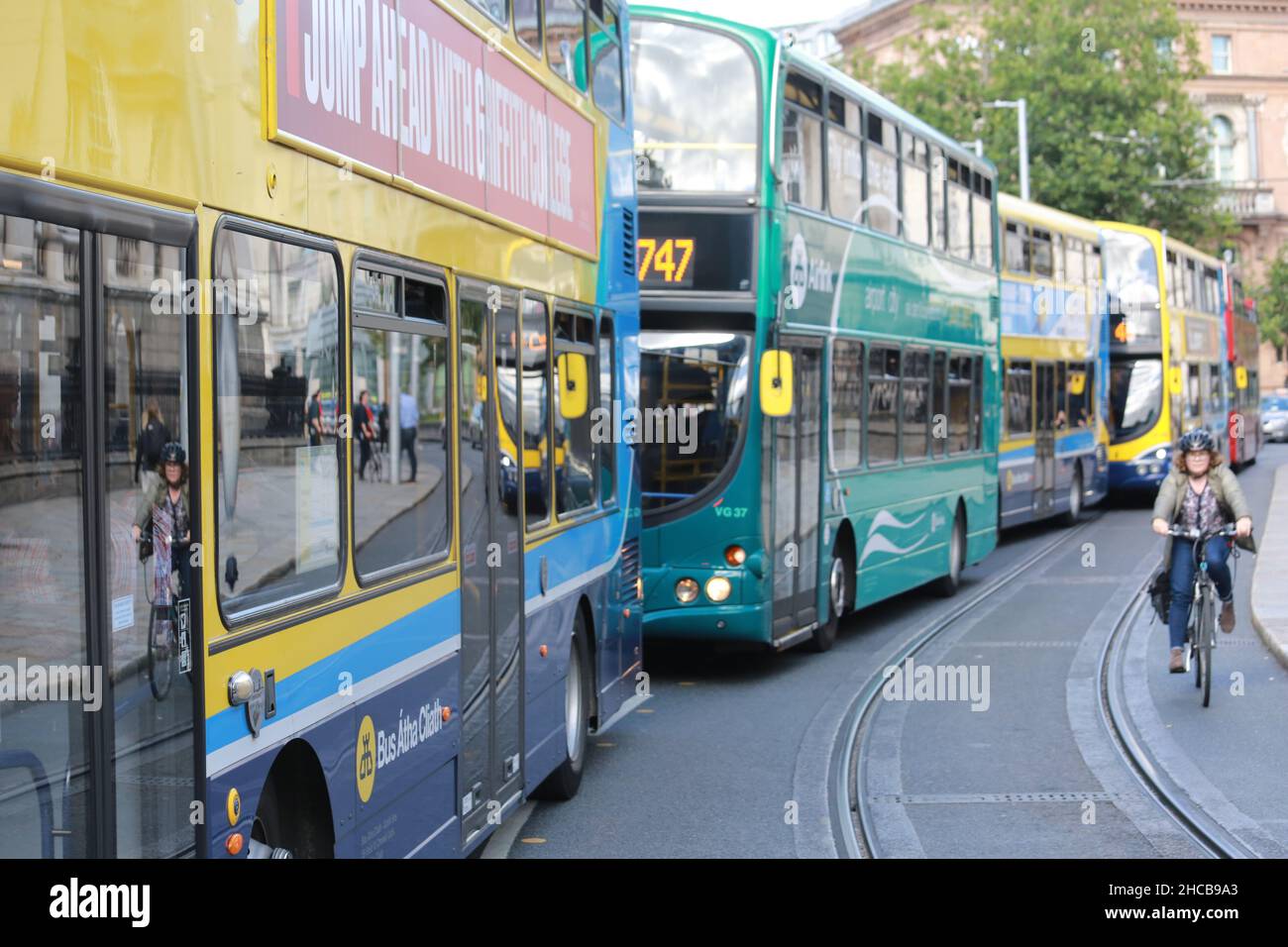 Buses and a cyclist near Trinity College in Dublin Stock Photo - Alamy