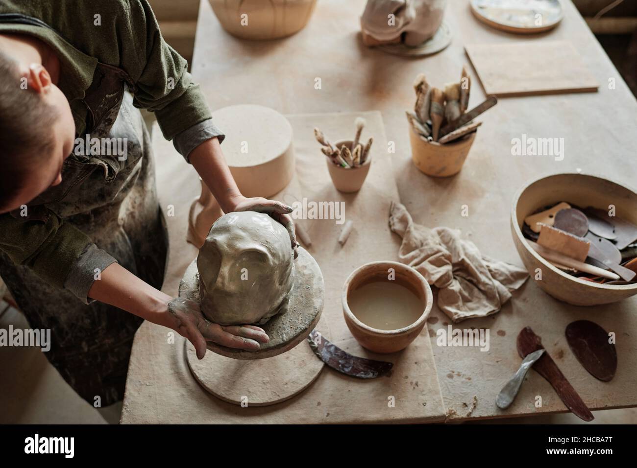 Sculptor using patterns and special equipment to make human face from ...