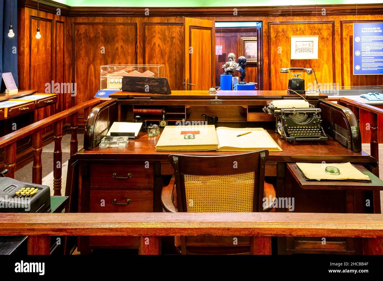 The desk, furniture, and equipment of an old bank branch are seen in ...