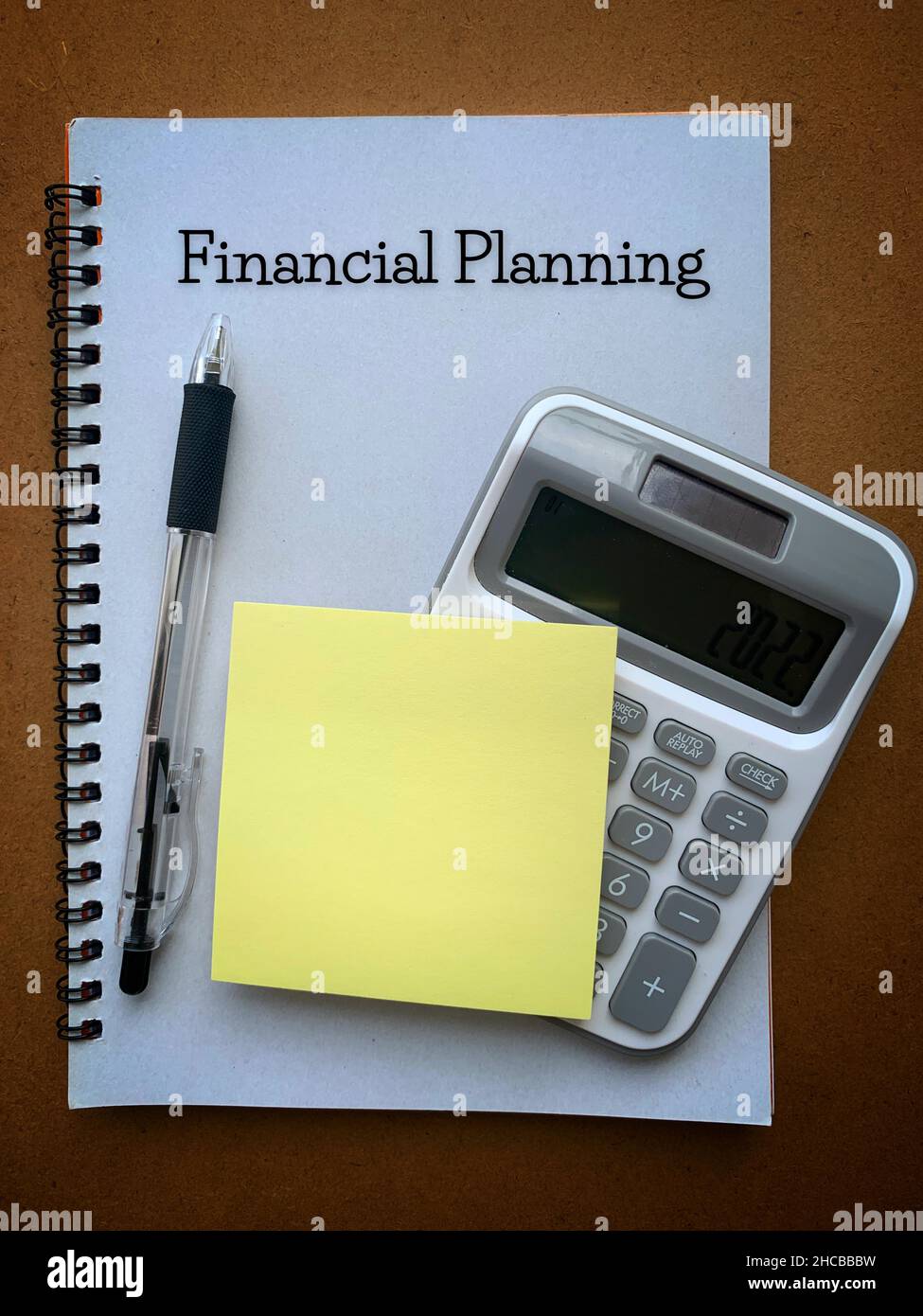 Financial planning text on notepad with pen, calculator and sticky note background Stock Photo ...