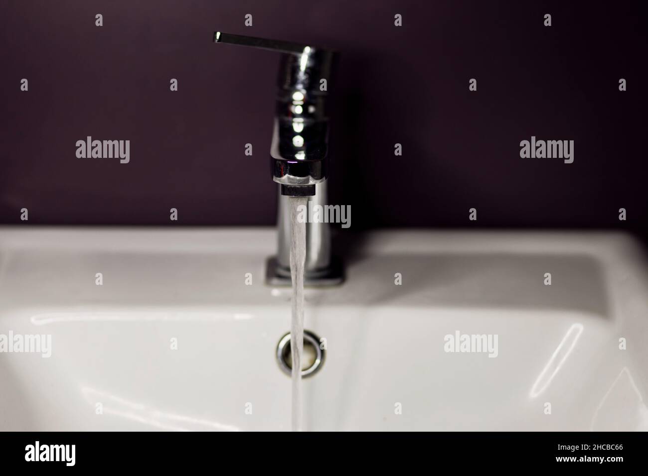 Open chrome faucet washbasin. working water tap Stock Photo - Alamy