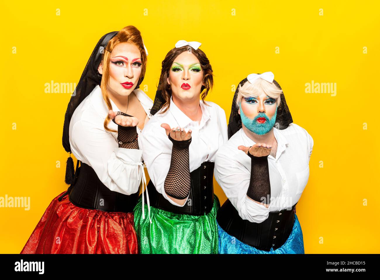 Bearded man in costume of drag queen standing with hand on hip against ...
