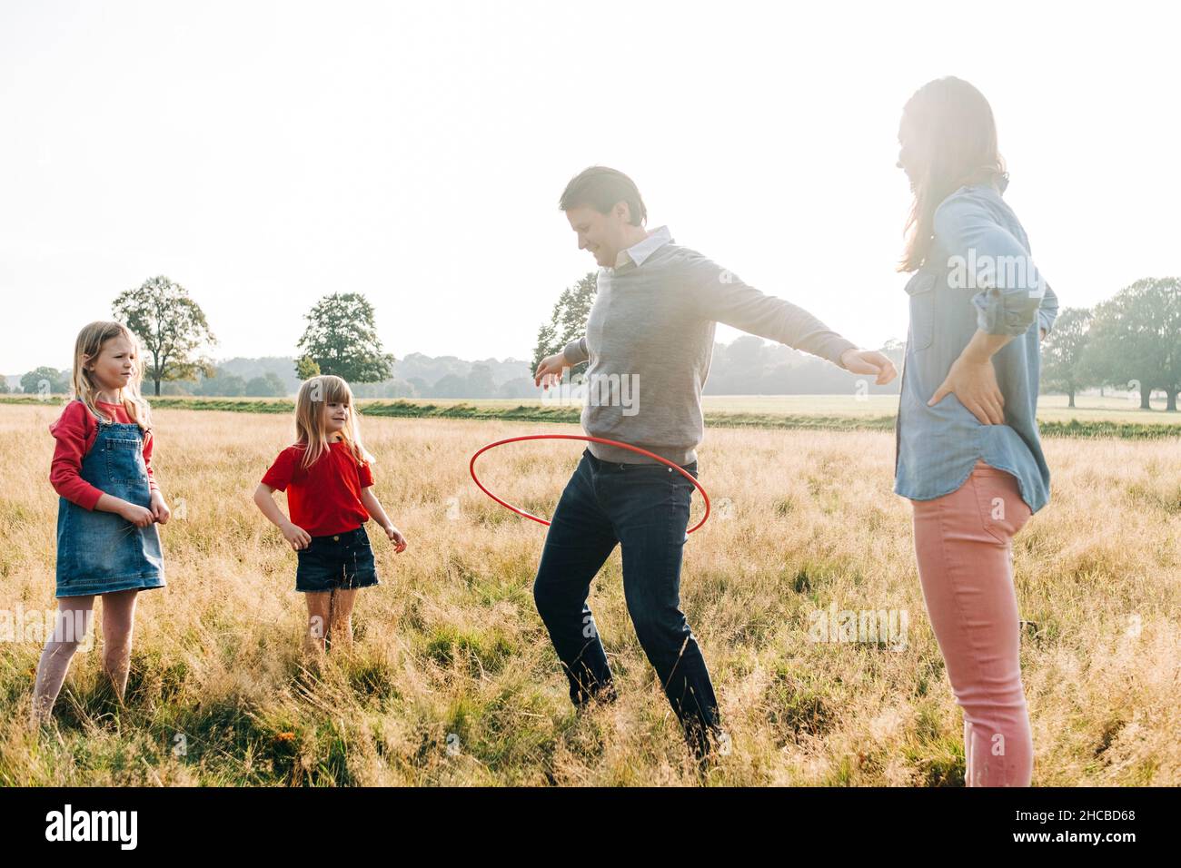 Father playing with daughters outdoors hi-res stock photography and ...