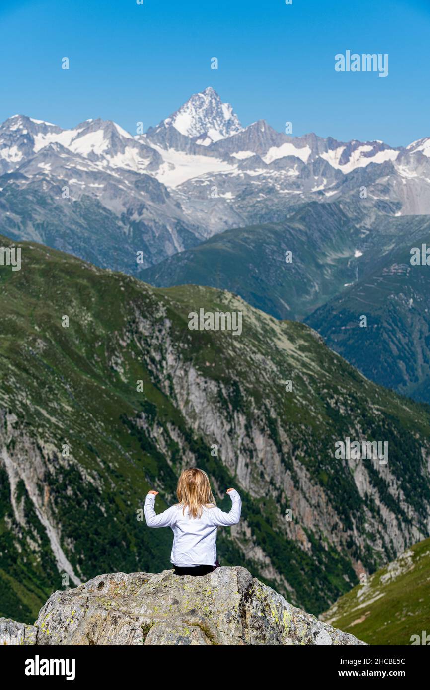 Girl flexing muscles top rock looking mountains hi-res stock ...