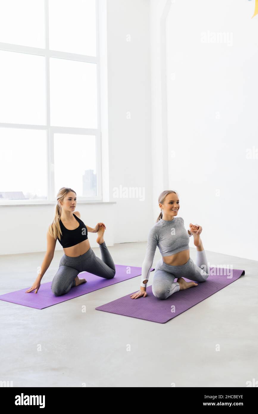 Two attractive sport girls workout stretching in gym Stock Photo - Alamy
