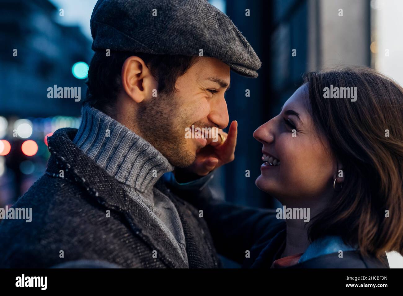 Happy girlfriend and boyfriend looking at each other Stock Photo - Alamy