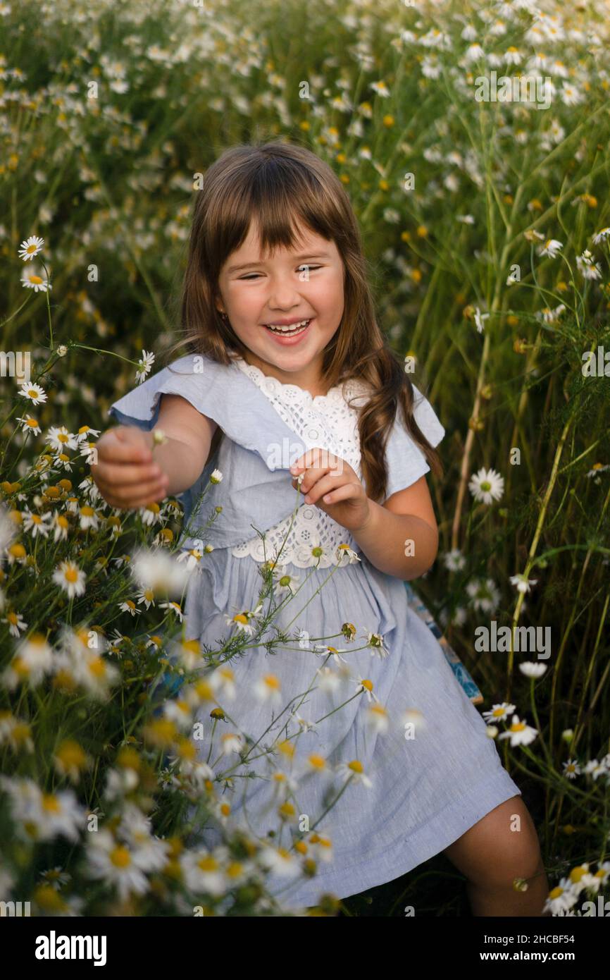 Happy Little Girl With Flower