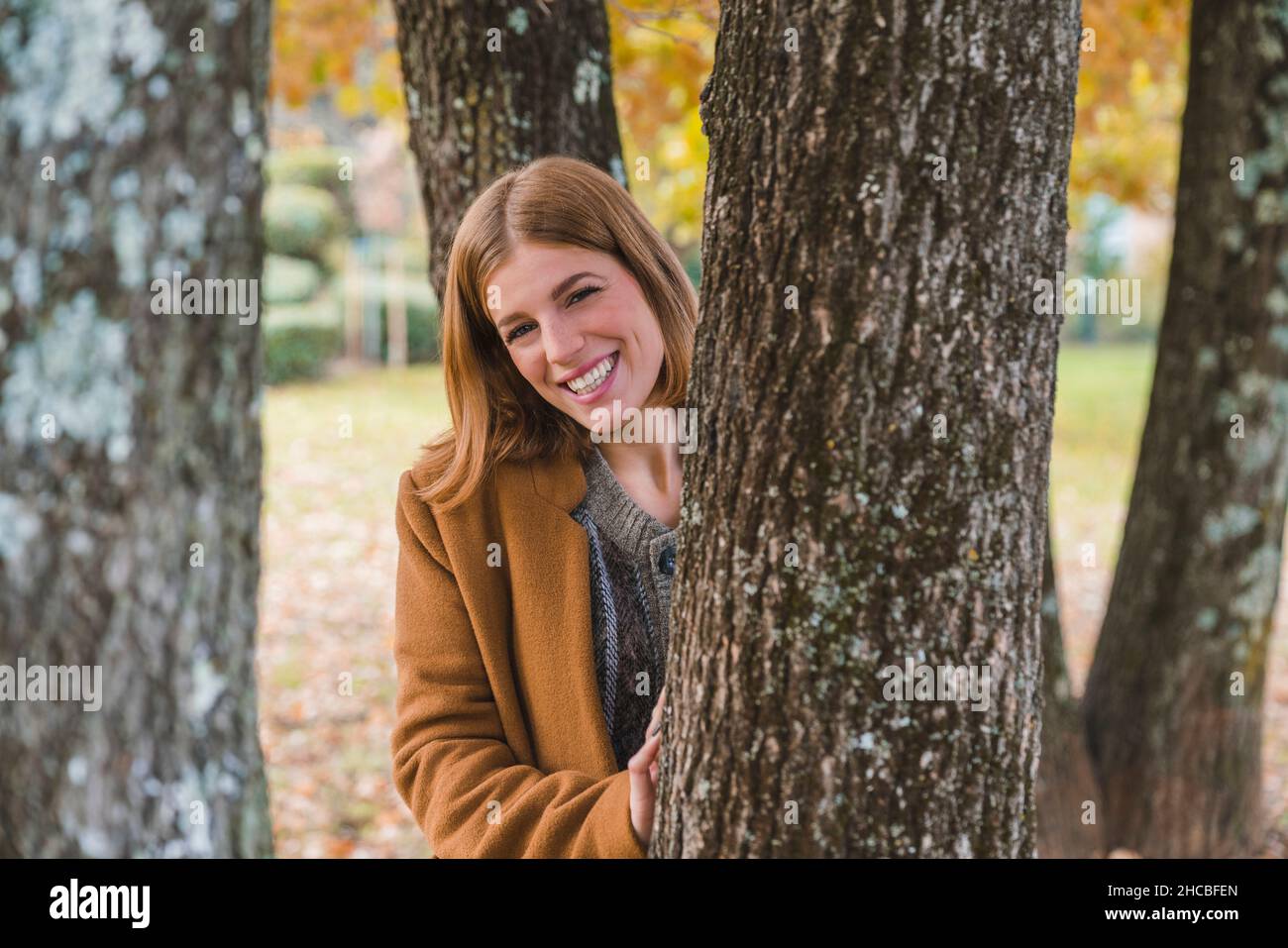 Woman standing at tree hi-res stock photography and images - Alamy