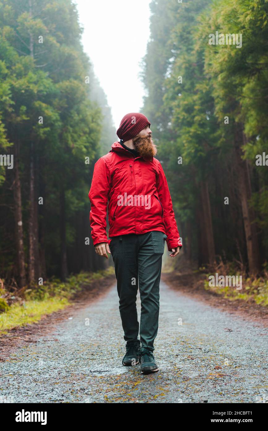 Young man walking on road hi-res stock photography and images - Alamy