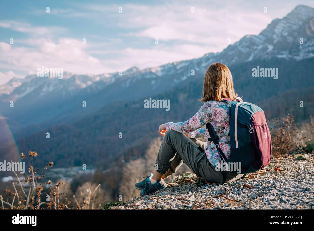 Tourist with backpack resting on mountain Stock Photo - Alamy