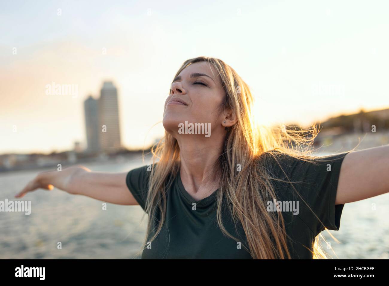 Woman arms outstretched bogatell beach hi-res stock photography and ...