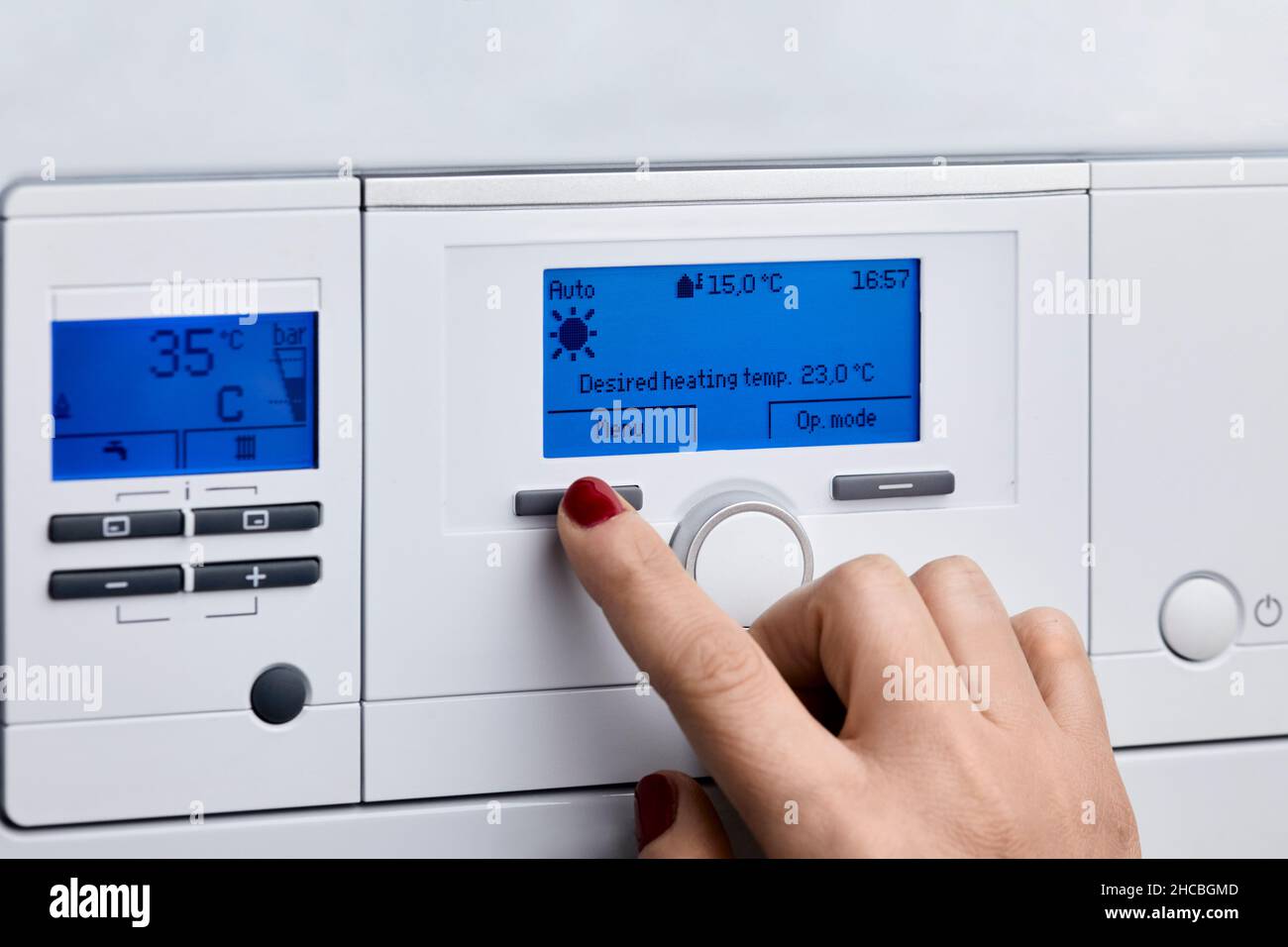 Woman adjusting control panel of heating boiler at home Stock Photo - Alamy