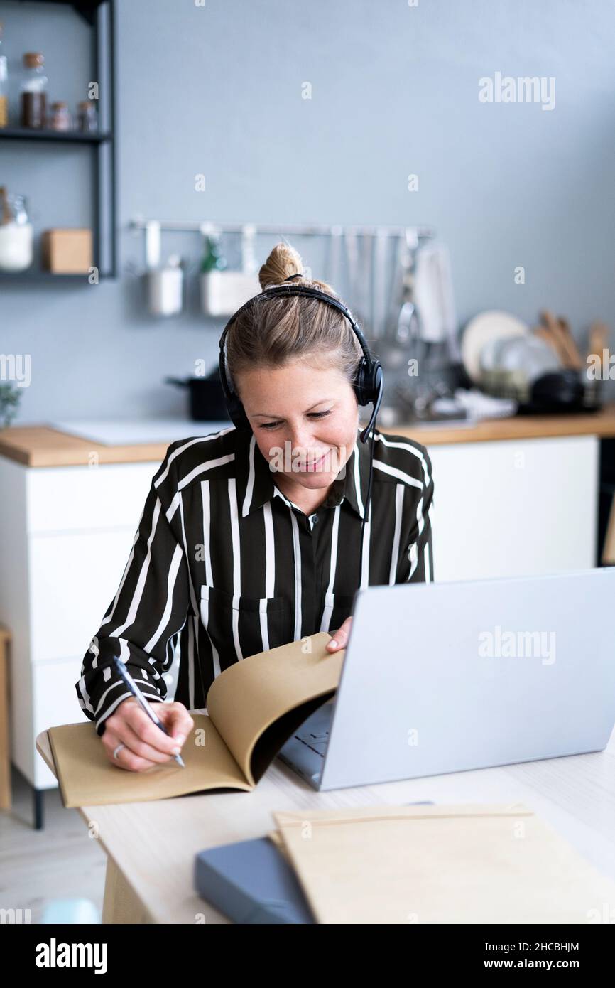 Woman working from home kitchen tablet hi-res stock photography and ...