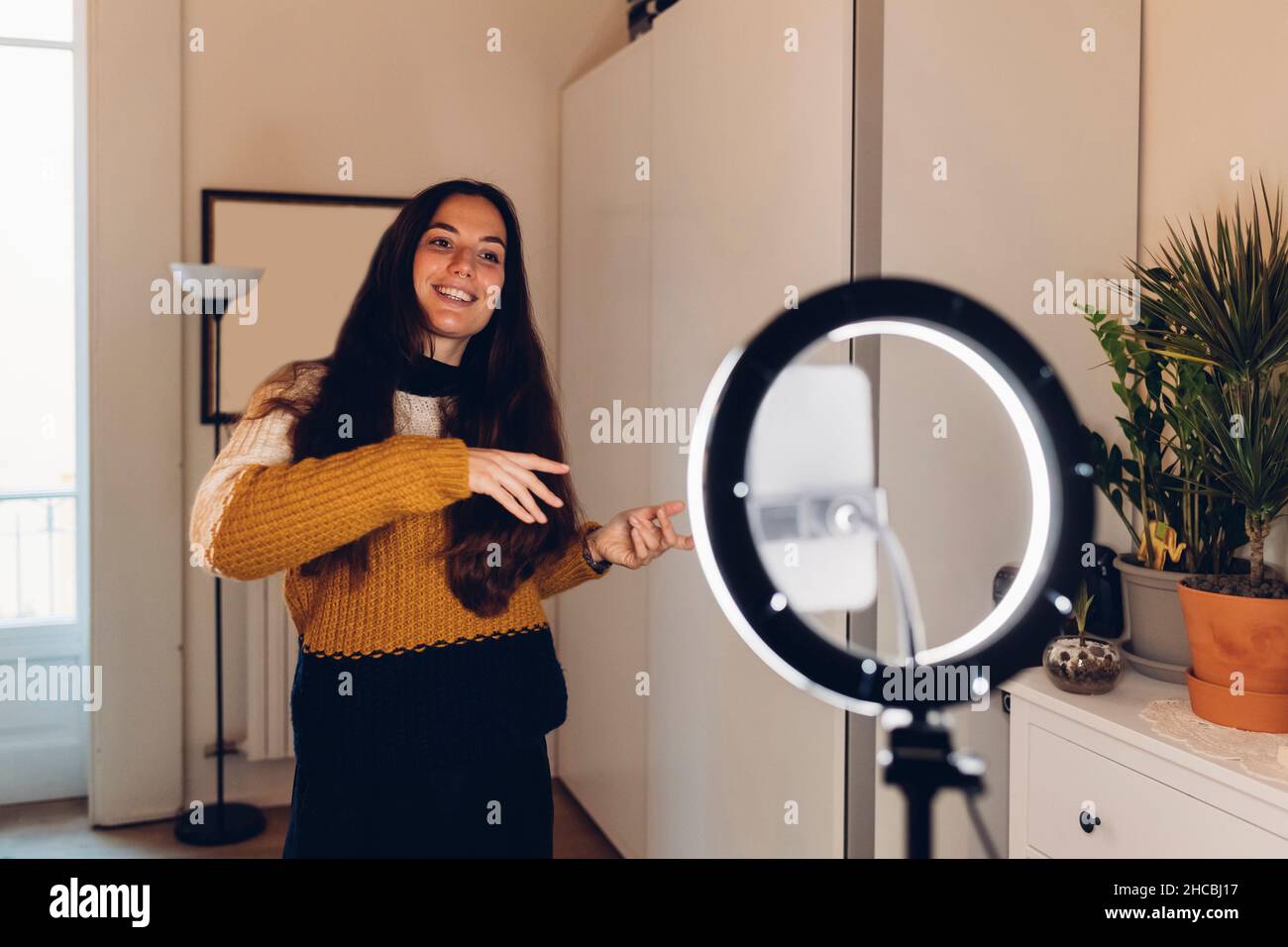 Influencer vlogging in front of ring light at home Stock Photo - Alamy