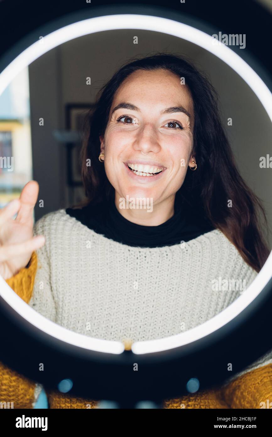 Influencer smiling in front of ring light Stock Photo - Alamy