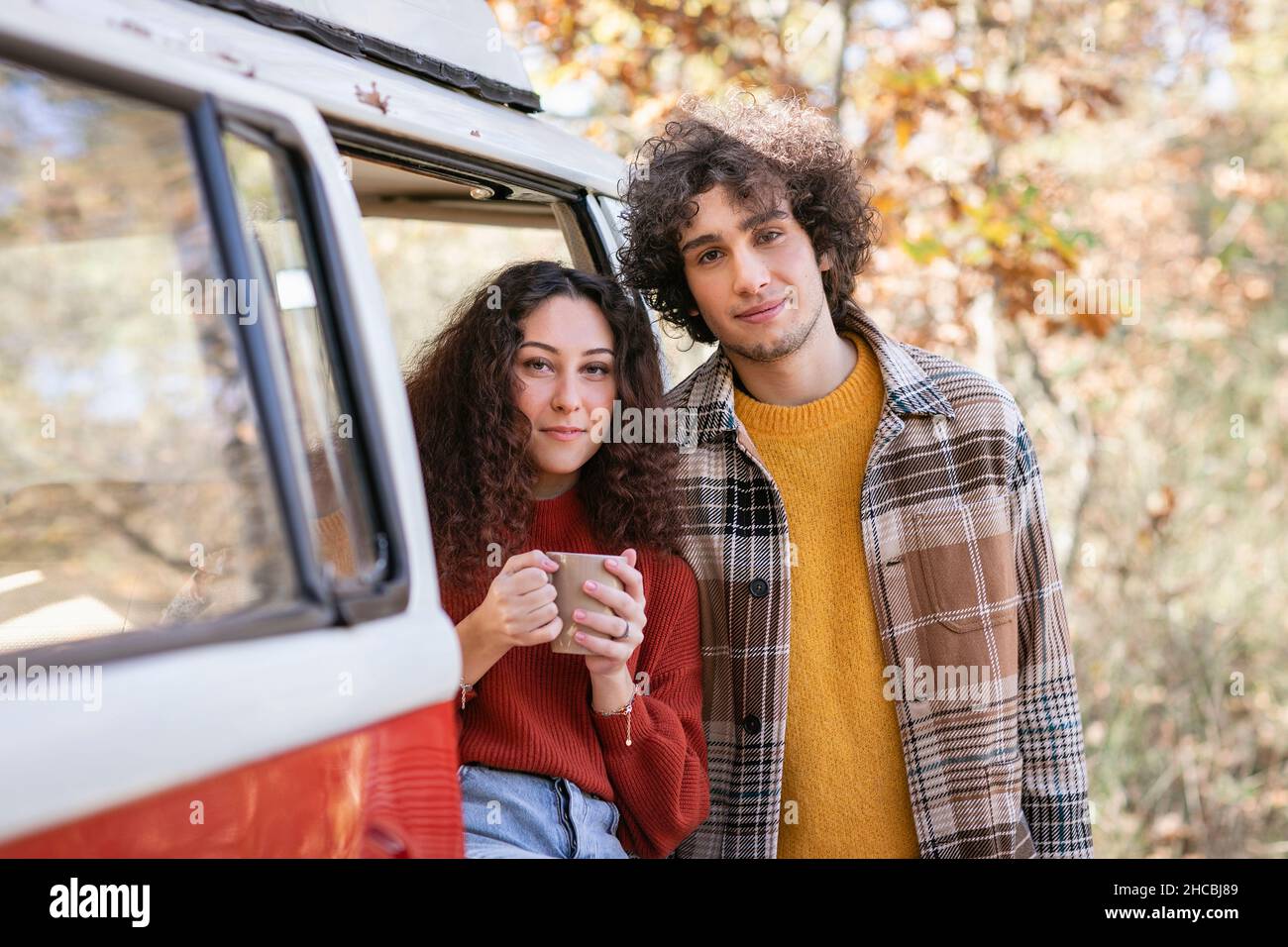 Young couple at campervan in autumn forest Stock Photo - Alamy