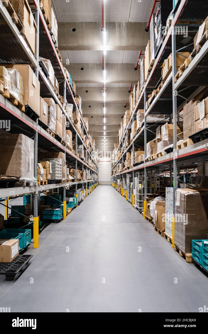 Boxes arranged on racks in factory Stock Photo - Alamy