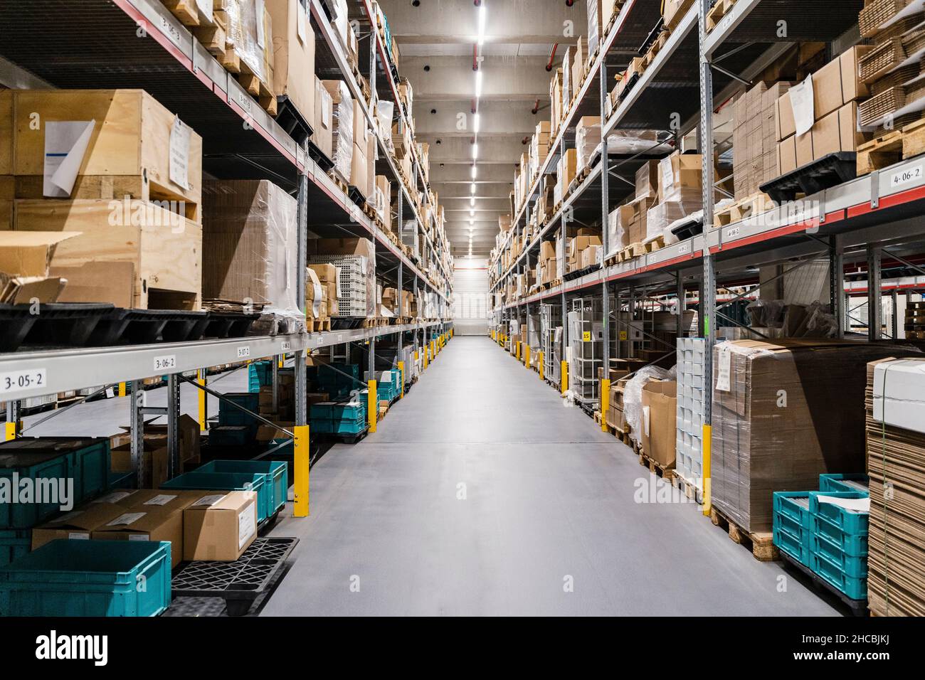 Boxes arranged on shelves in warehouse Stock Photo - Alamy