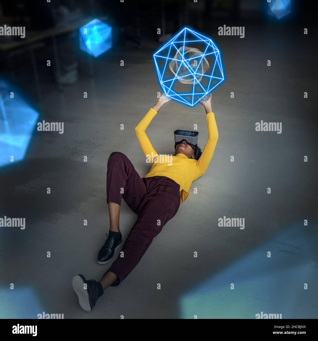 Businesswoman touching augmented blue shape through virtual reality ...
