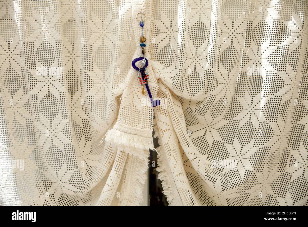 hand knitted curtains and amulets Stock Photo - Alamy