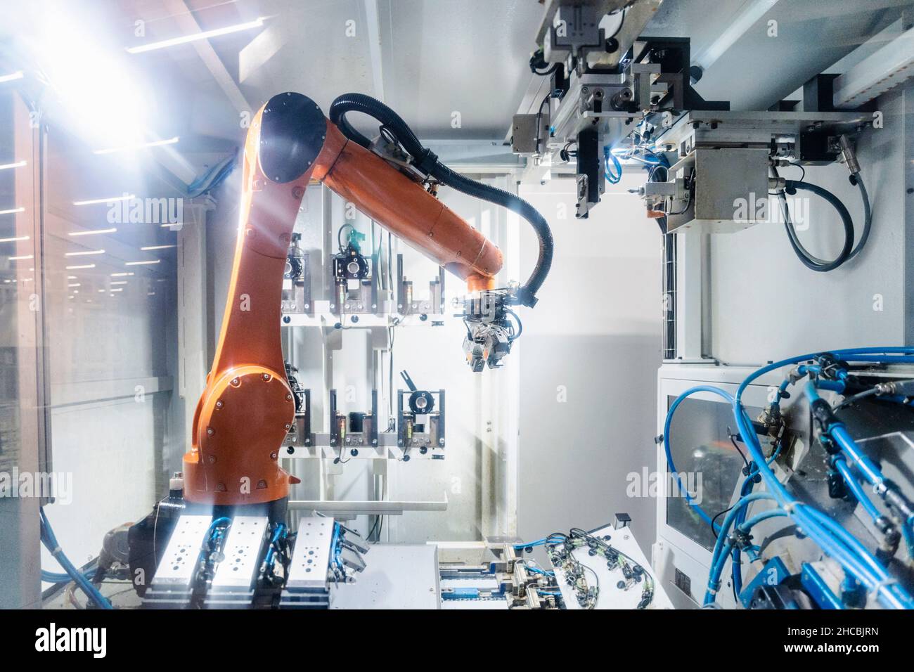 Illuminated robotic arm working in automated industry Stock Photo - Alamy