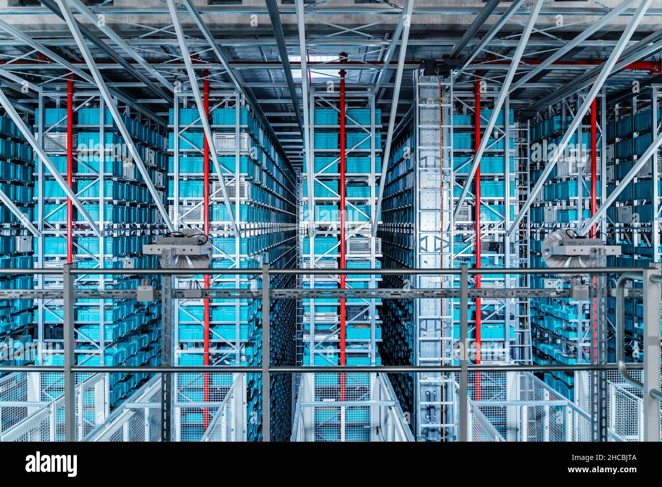Blue containers in racks side by side at warehouse Stock Photo - Alamy