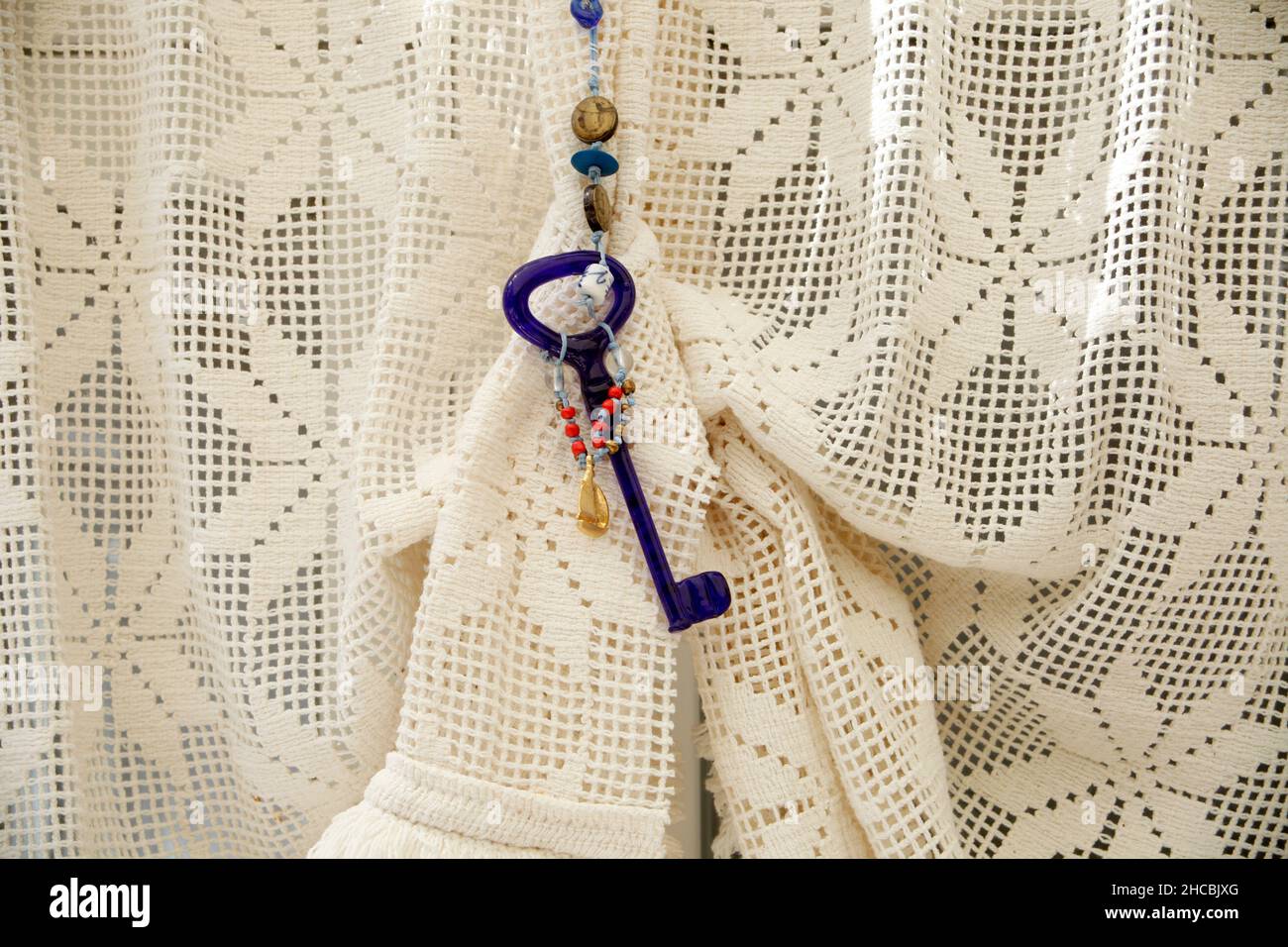 hand knitted curtains and amulets Stock Photo - Alamy