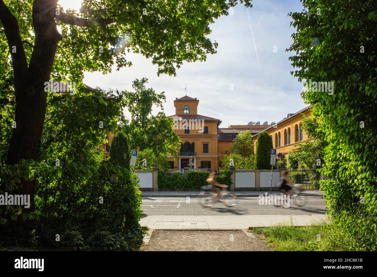 Germany, Bavaria, Munich, Two cyclists passing Lenbachhaus museum Stock ...