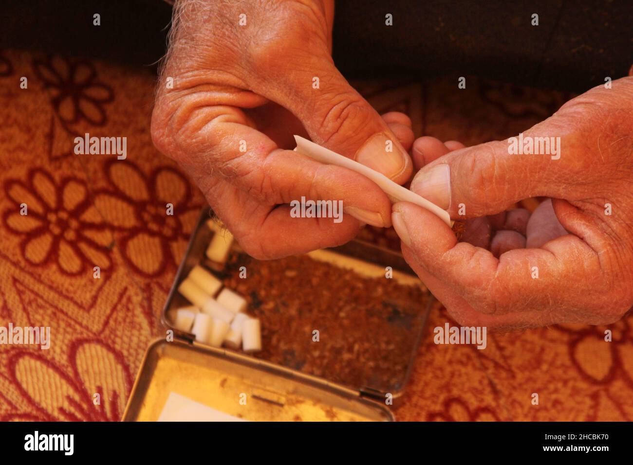 Hands of a man rolling tobacco. Addiction Stock Photo - Alamy